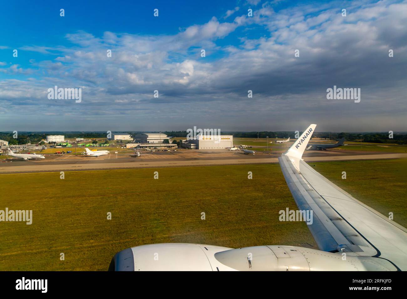 View through plane window at wingtip, Ryanair plane taking off London ...