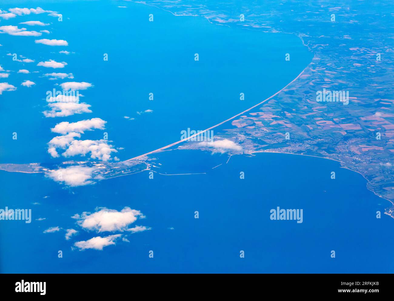 Oblique aerial view through plane window of Chisel Beach tombolo and ...