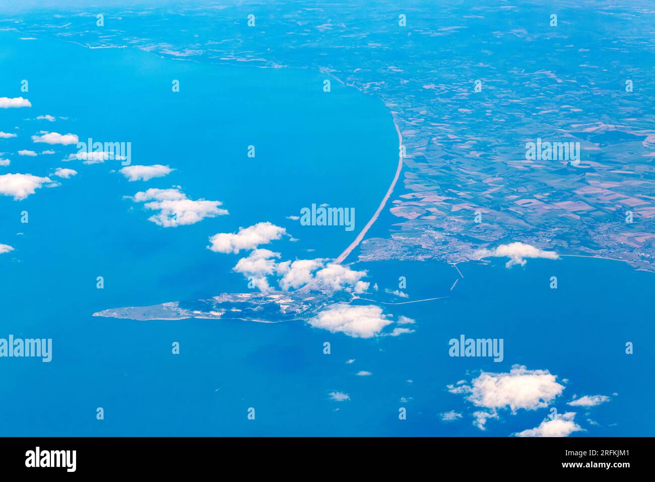 Oblique aerial view through plane window of Chisel Beach tombolo and ...