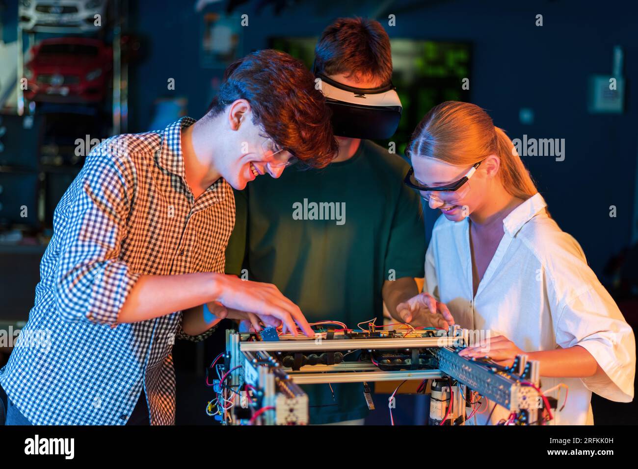 Group of teens doing experiments in robotics in a laboratory. Boys and ...