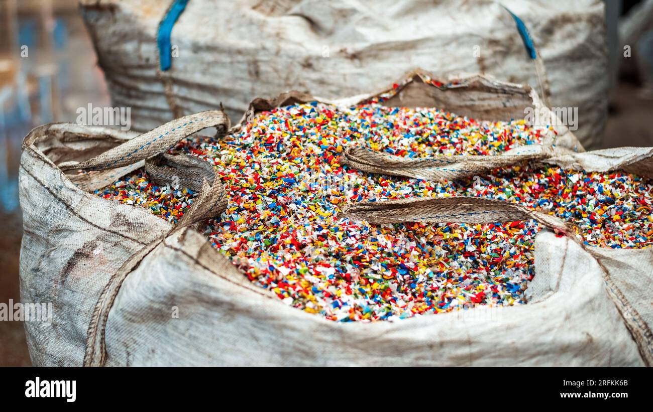 Sack of sorted multicoloured shredded plastic garbage at waste ...