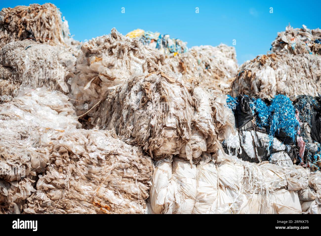 Multiple cubes of compressed plastic garbage near the waste recycling ...