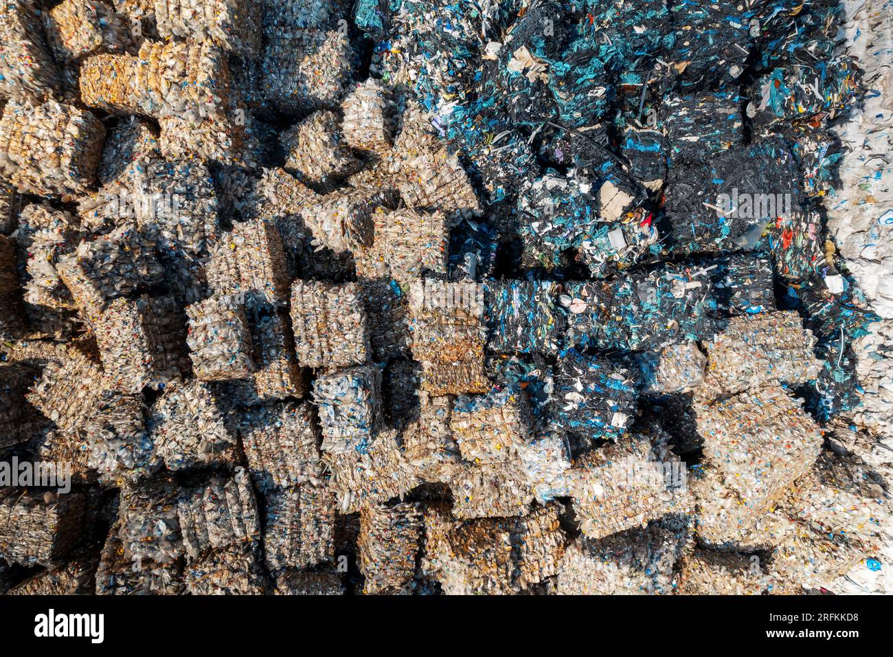 Multiple cubes of compressed plastic garbage near the waste recycling ...