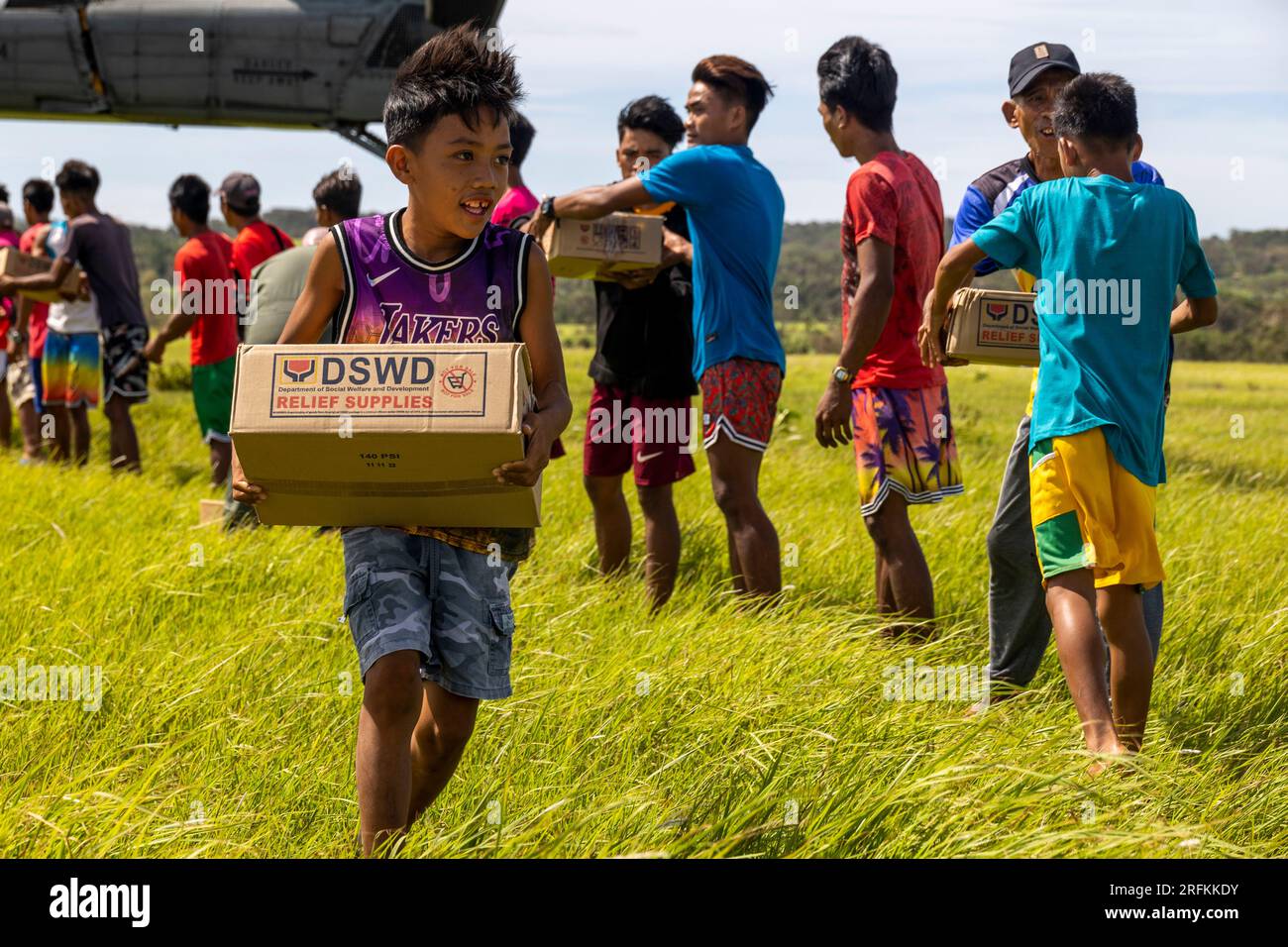 Basco, Philippines. 03rd Aug, 2023. Filipino volunteers help unload ...