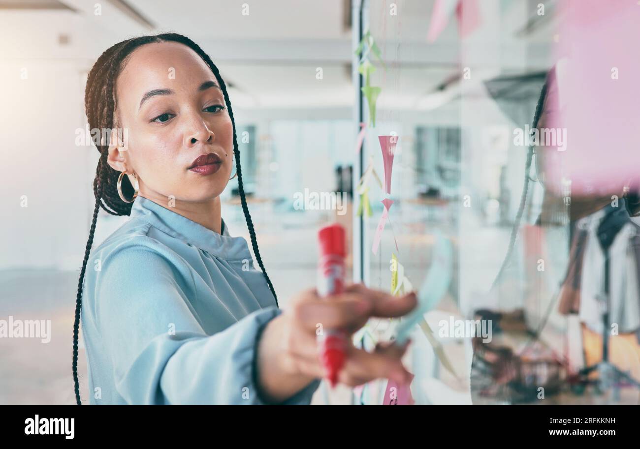 Woman at glass with ideas, marker and notes for business planning ...