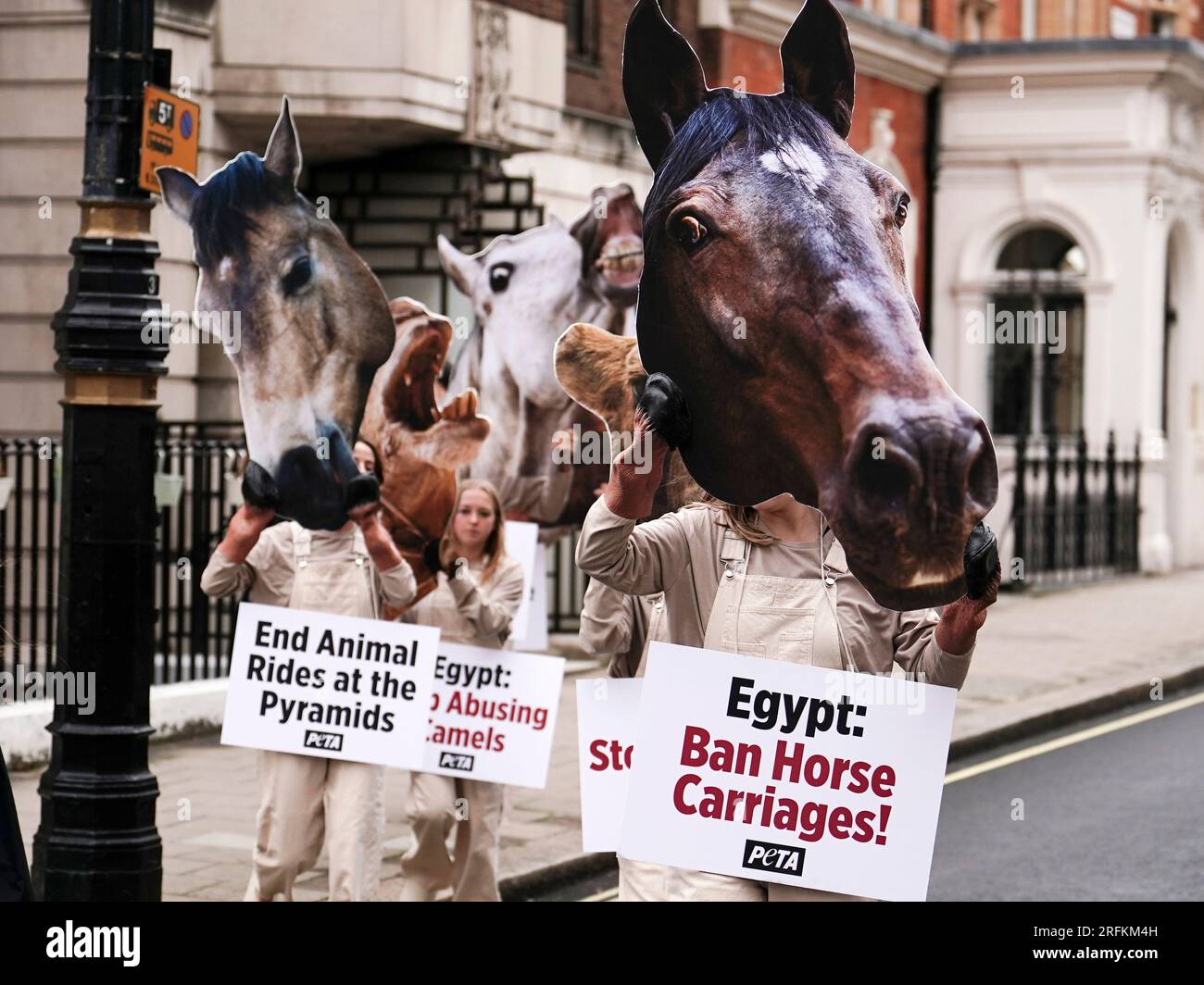 Activists from PETA wearing "hooves" and giant horse and camel masks ...