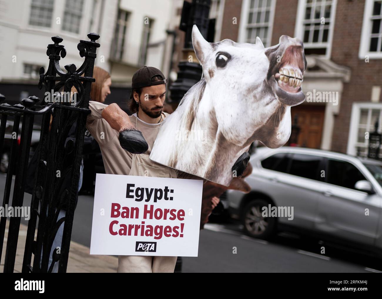 Activists from PETA wearing "hooves" and giant horse and camel masks ...