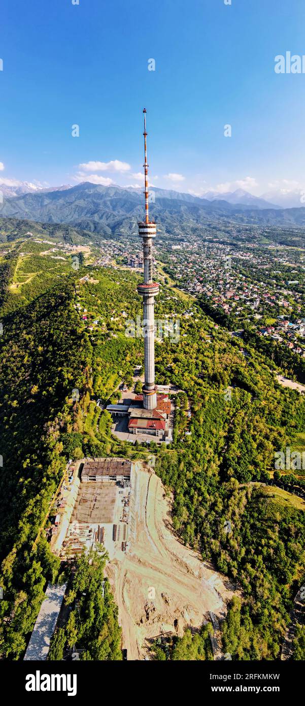 Vertical Aerial drone shot of symbol Almaty city high TV tower and park ...