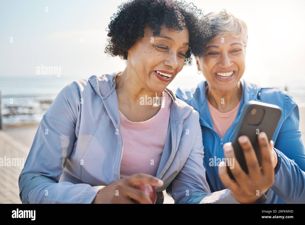 Senior women, phone and social media in nature for a chat, notification ...
