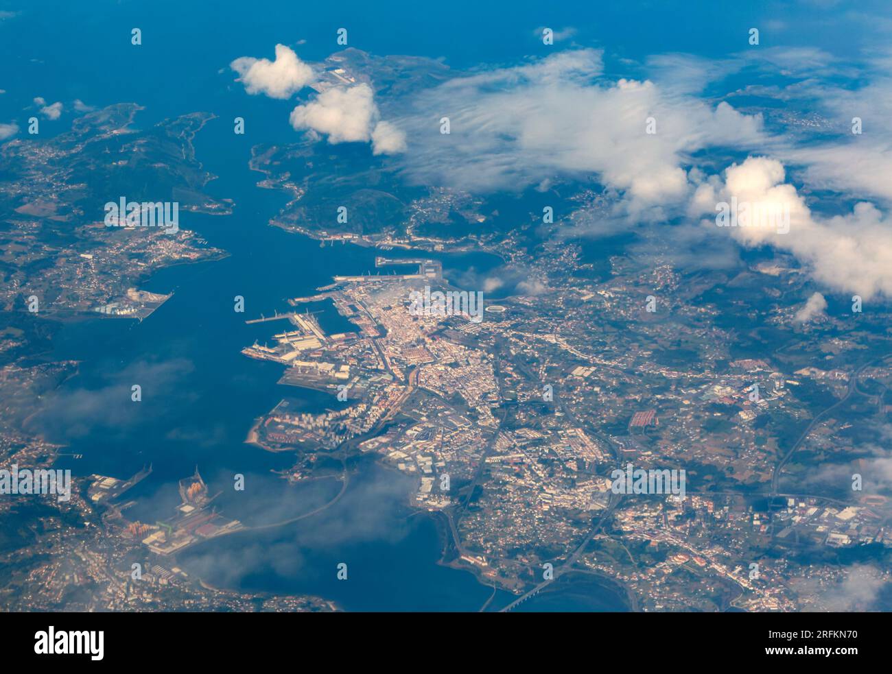 View through plane window, oblique aerial view of port city of Ferrol ...