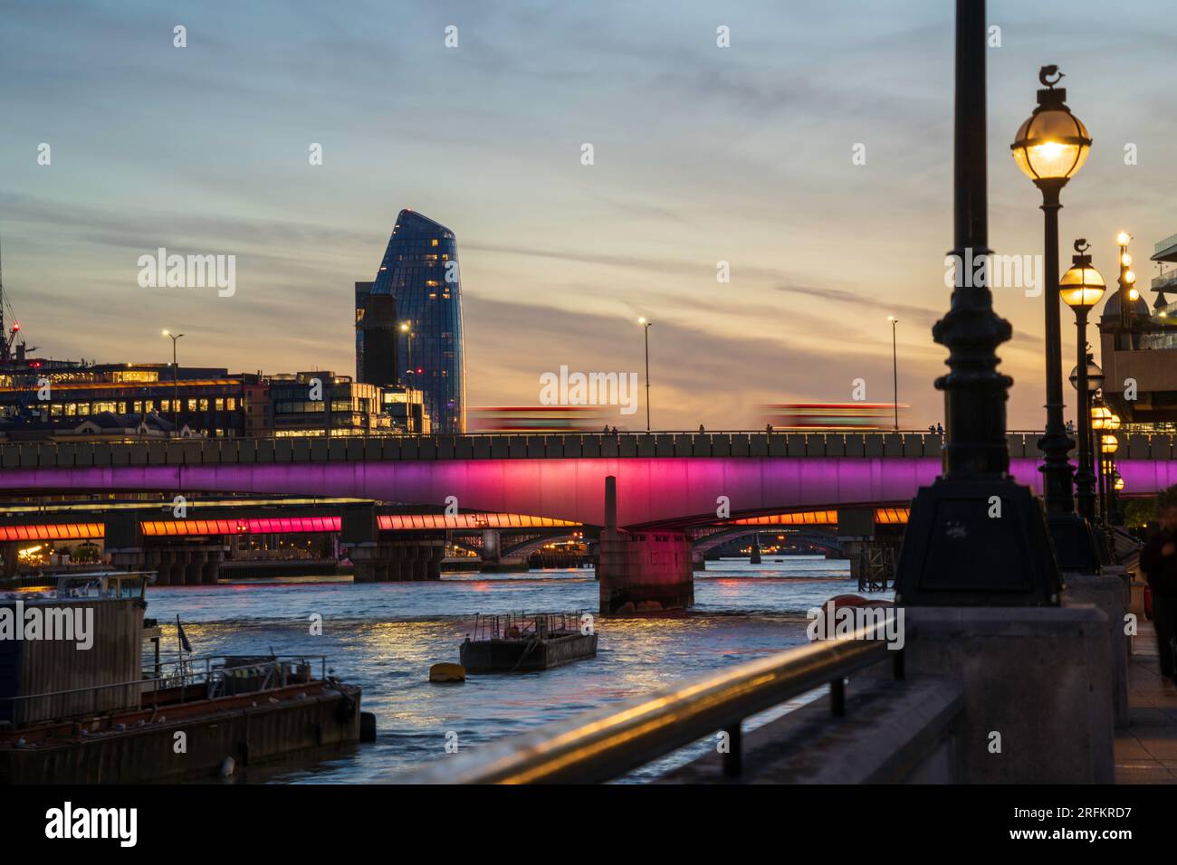 London skyline, the London Bridge at dusk, sunset, with colorful lights ...