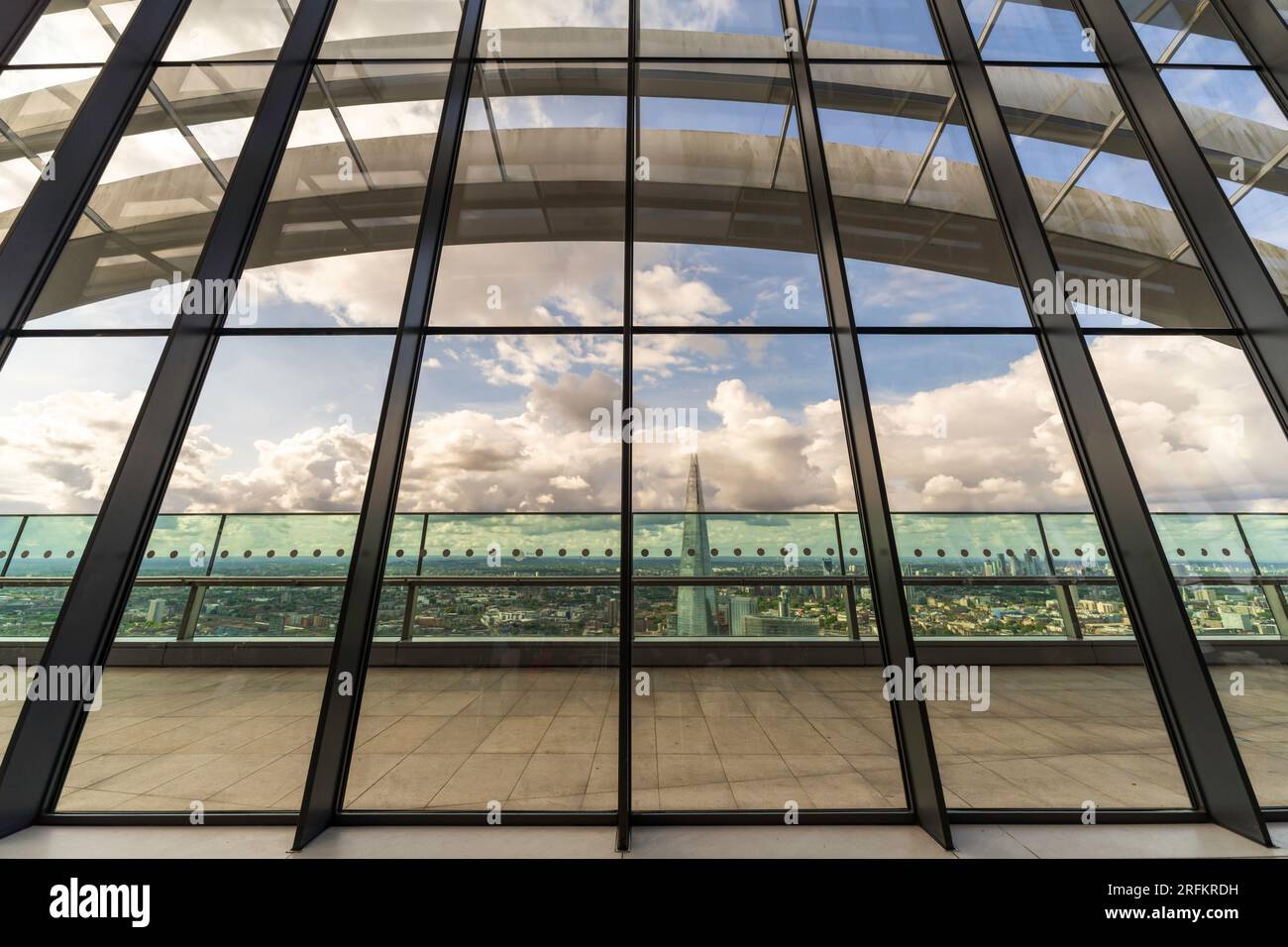 London cityscape with clouds and city buildings, from inside a modern ...