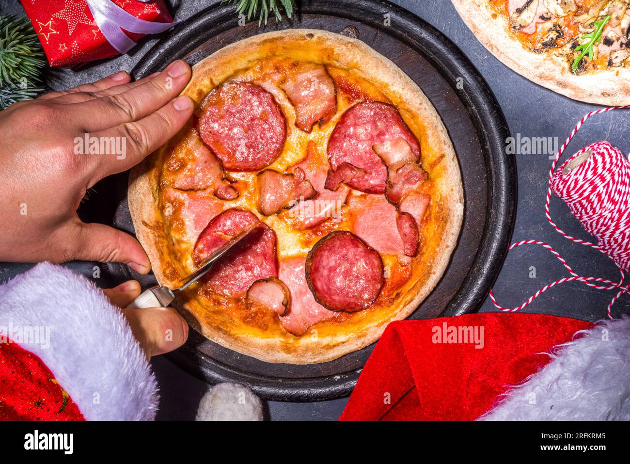 Christmas decorated background with pepperoni and mushrooms pizza,with ...