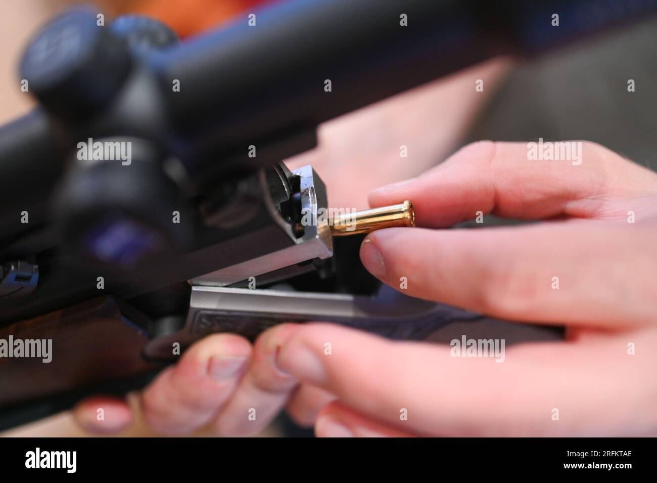 Murrhardt, Germany. 03rd Aug, 2023. A hunter inserts a centerfire 22 ...