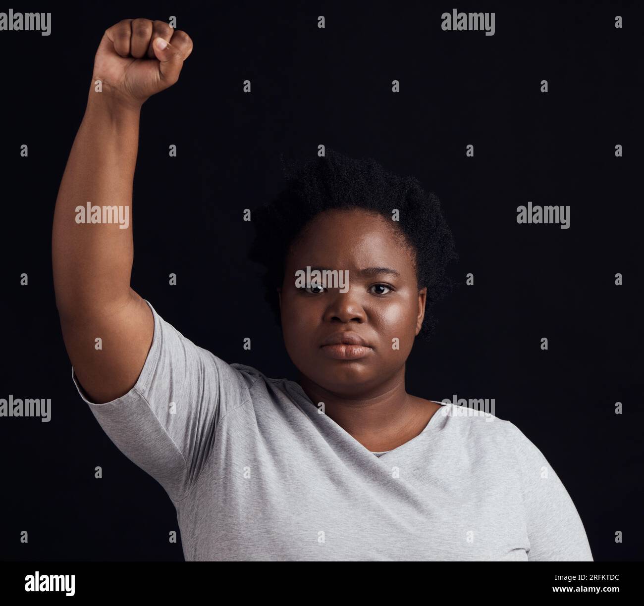Portrait, serious and black woman on a studio background for a protest ...