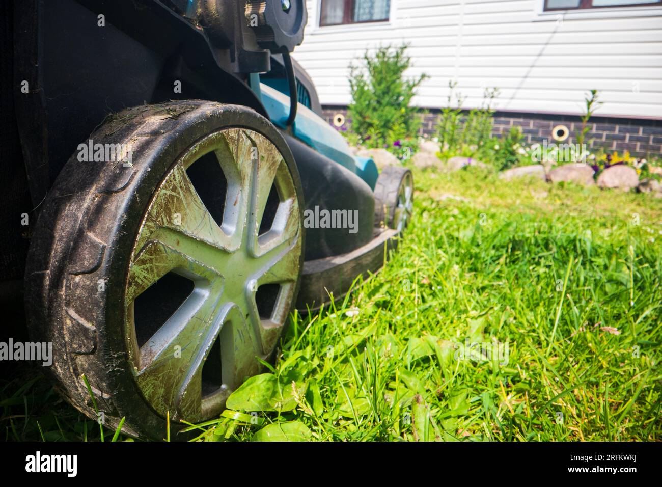 Lawn mover on green grass in modern garden or backyard. Machine for ...