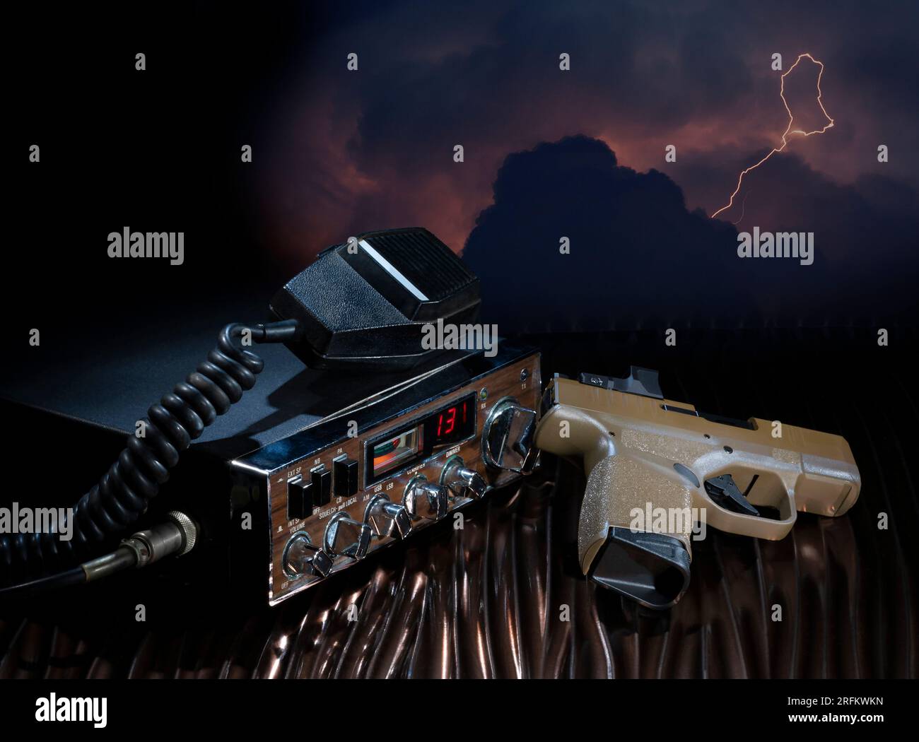 Emergency radio and pistol with storm coming from behind Stock Photo ...