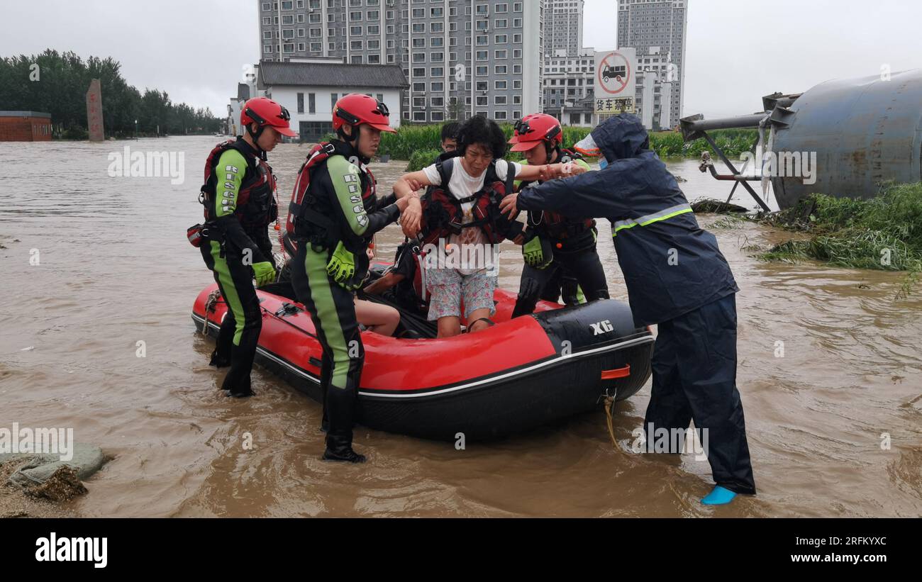 Harbin. 4th Aug, 2023. Firefighters rescue stranded villagers in the ...