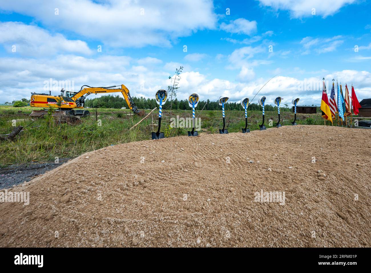 04 August 2023, Bavaria, Grafenwöhr: Shovels are stuck in the ground ...