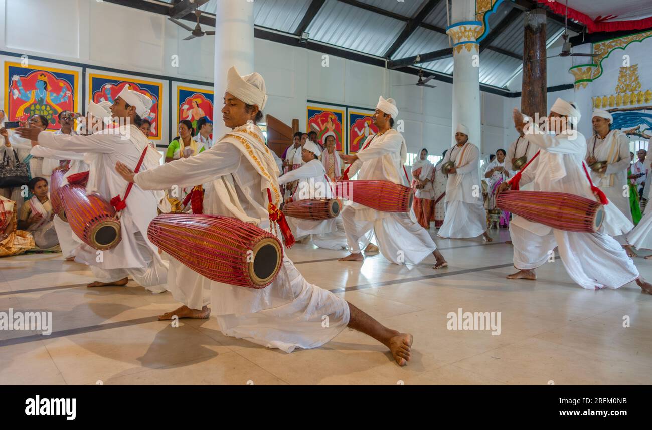 Hindu monks (bhaktis) drumming and dancing Uttar Kamalabari Satra (monastery) on Majuli Island ...