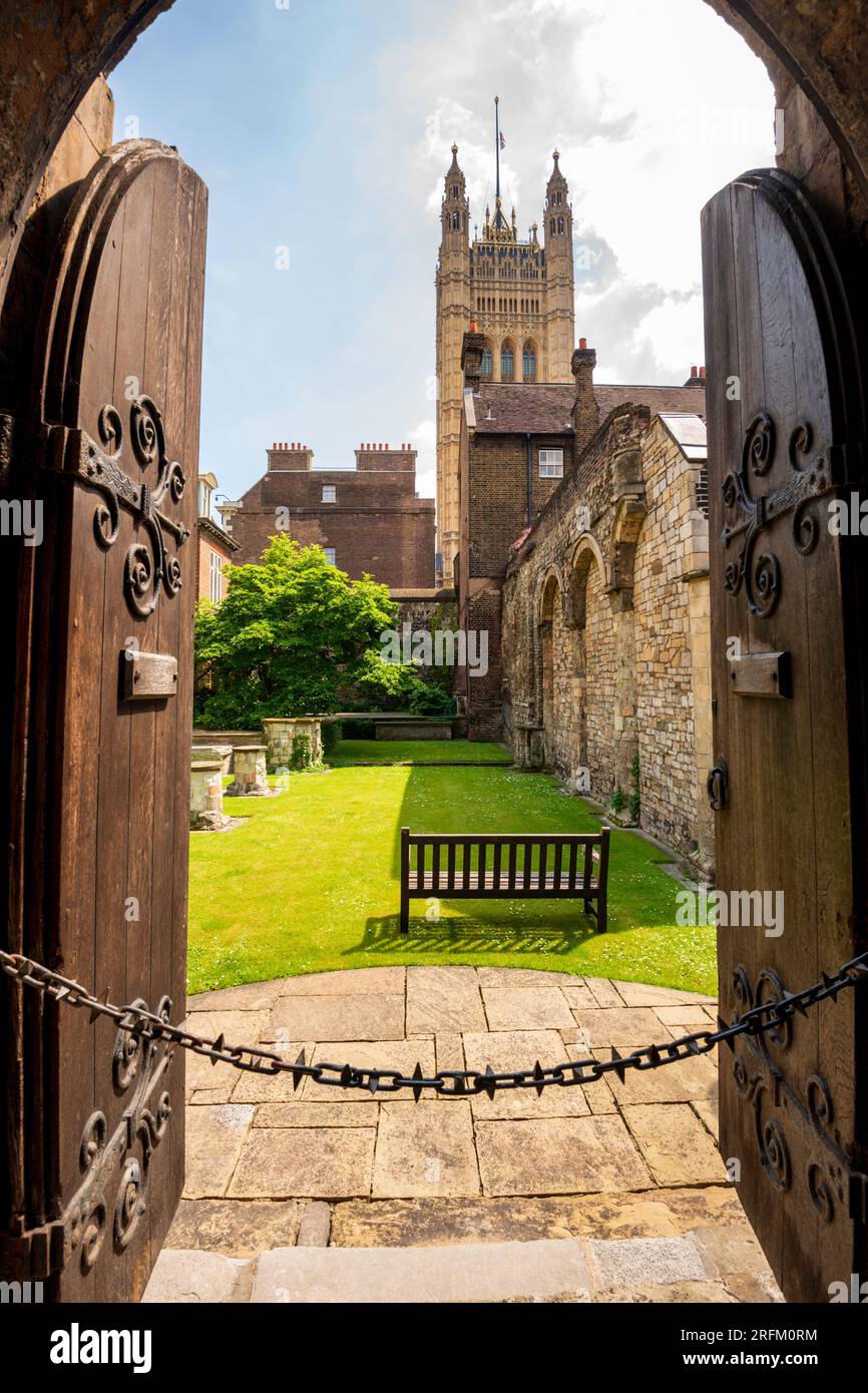 Looking through old medieval wooden doors and archway into a historic ...