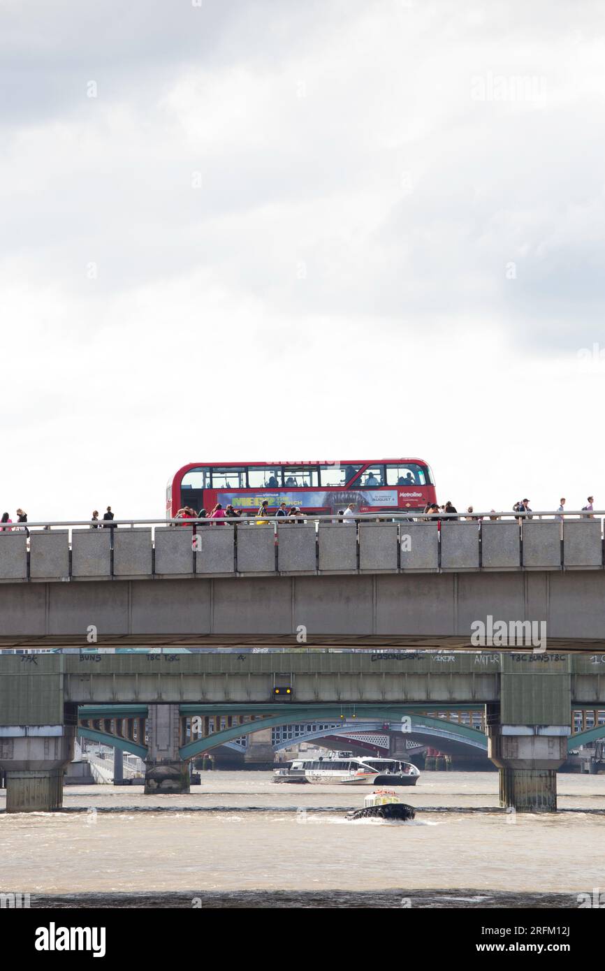 Red London Bus on the river Thames with commuters Stock Photo - Alamy