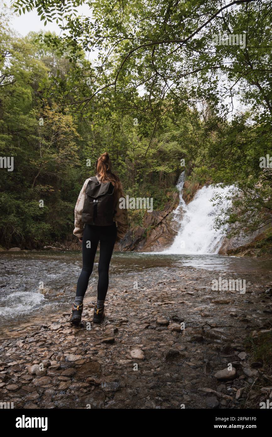 Woman next to waterfall hi-res stock photography and images - Alamy