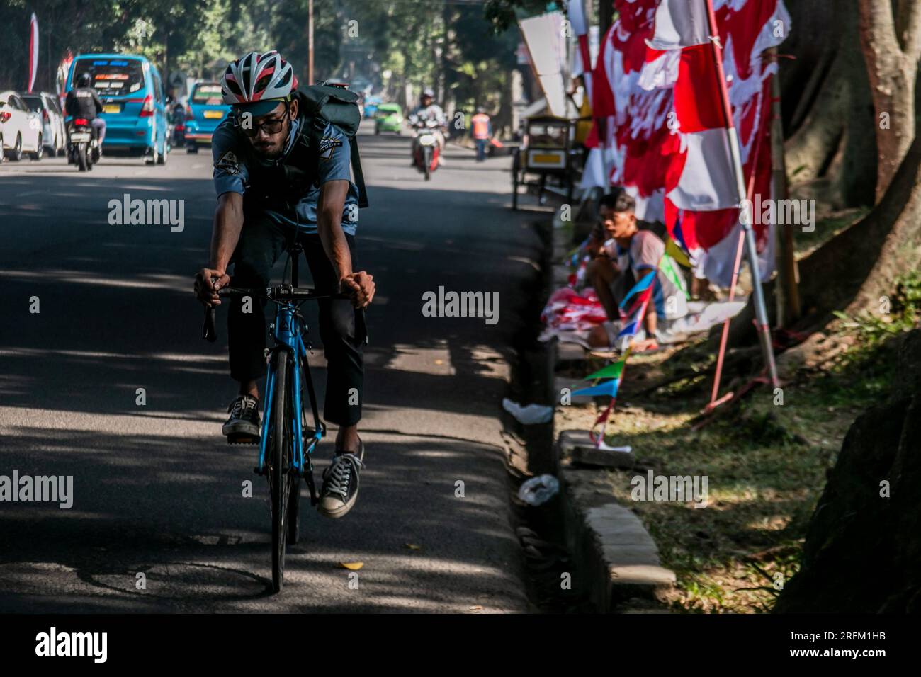 Bogor, Indonesia - August 01, 2023: Cyclists walk past traders with red ...