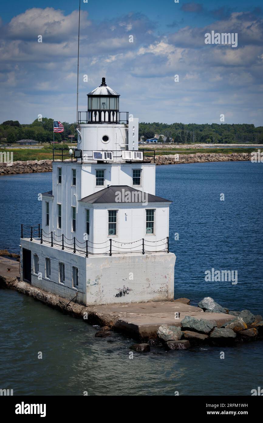 An American flag flies over the north pier lighthouse on the Lake ...