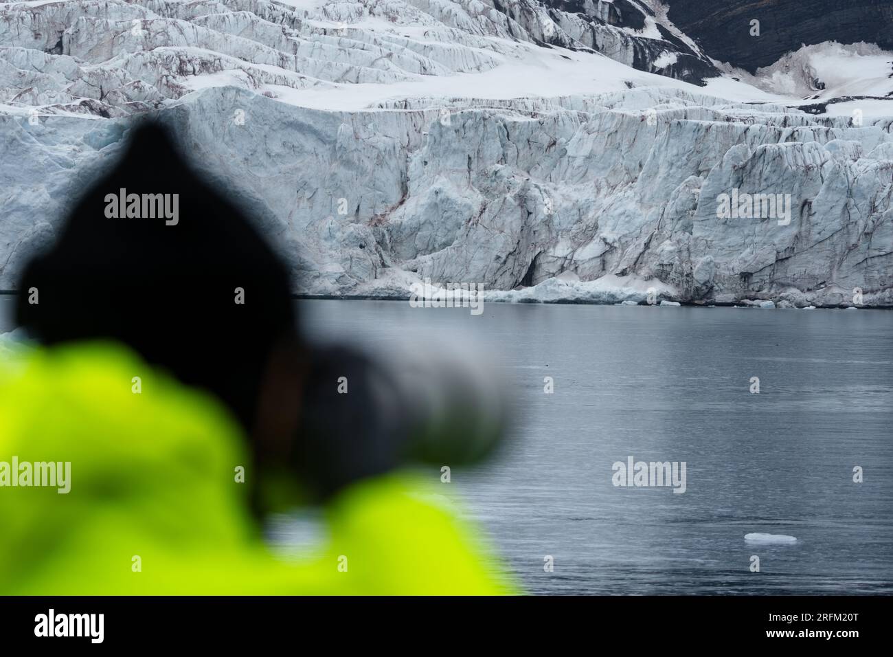 Photographer watching the arctic landscape of Svalbard from a ship ...