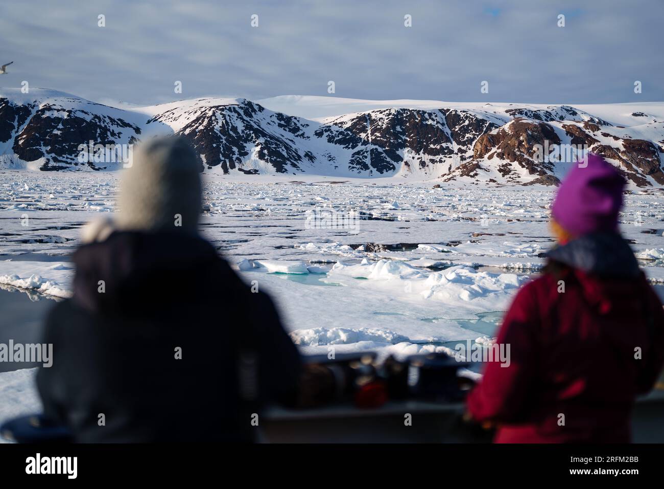 People watching the arctic landscape of Svalbard from a ship Stock ...