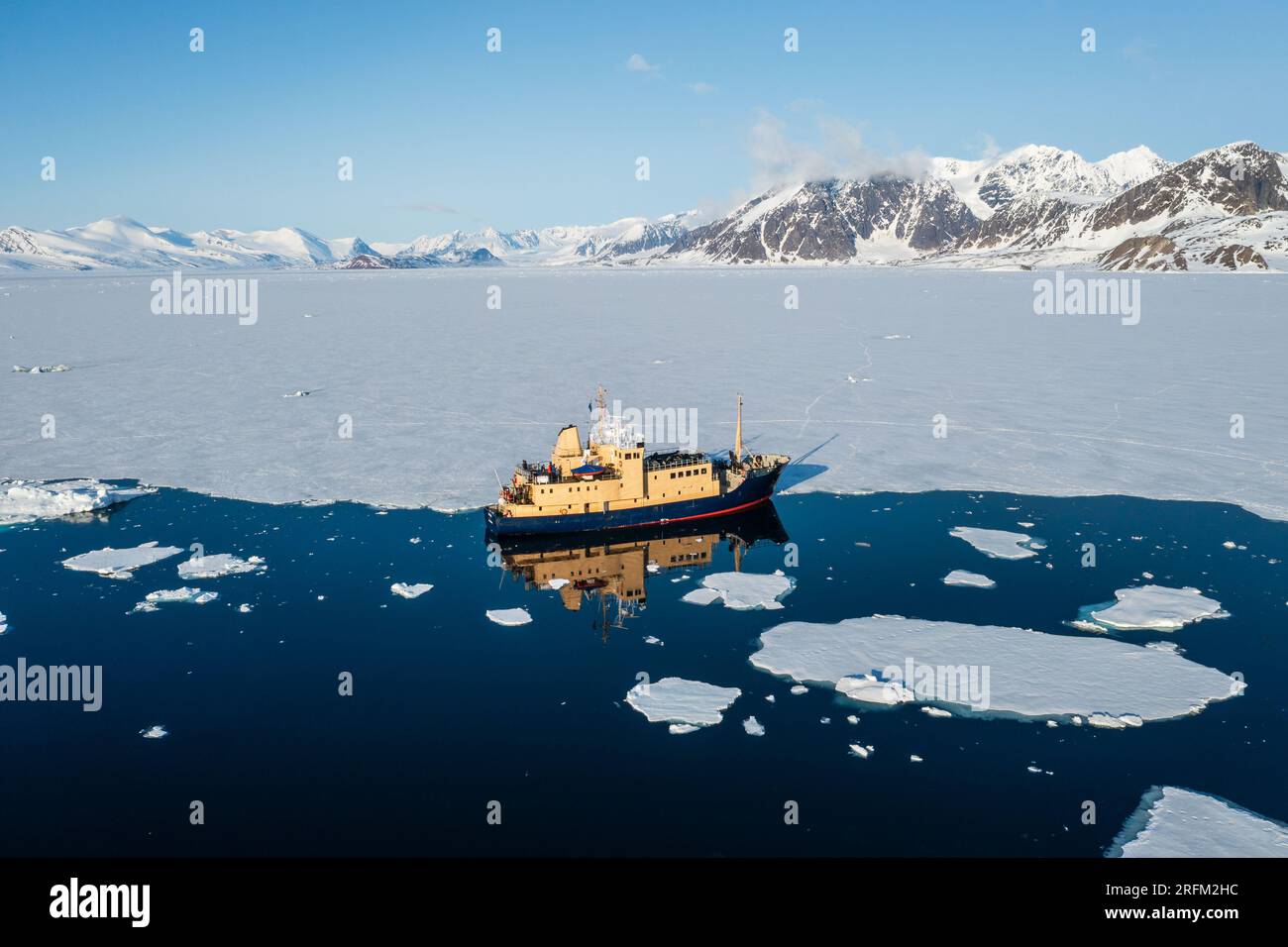 Ship cruising through the ice in Svalbard Stock Photo - Alamy