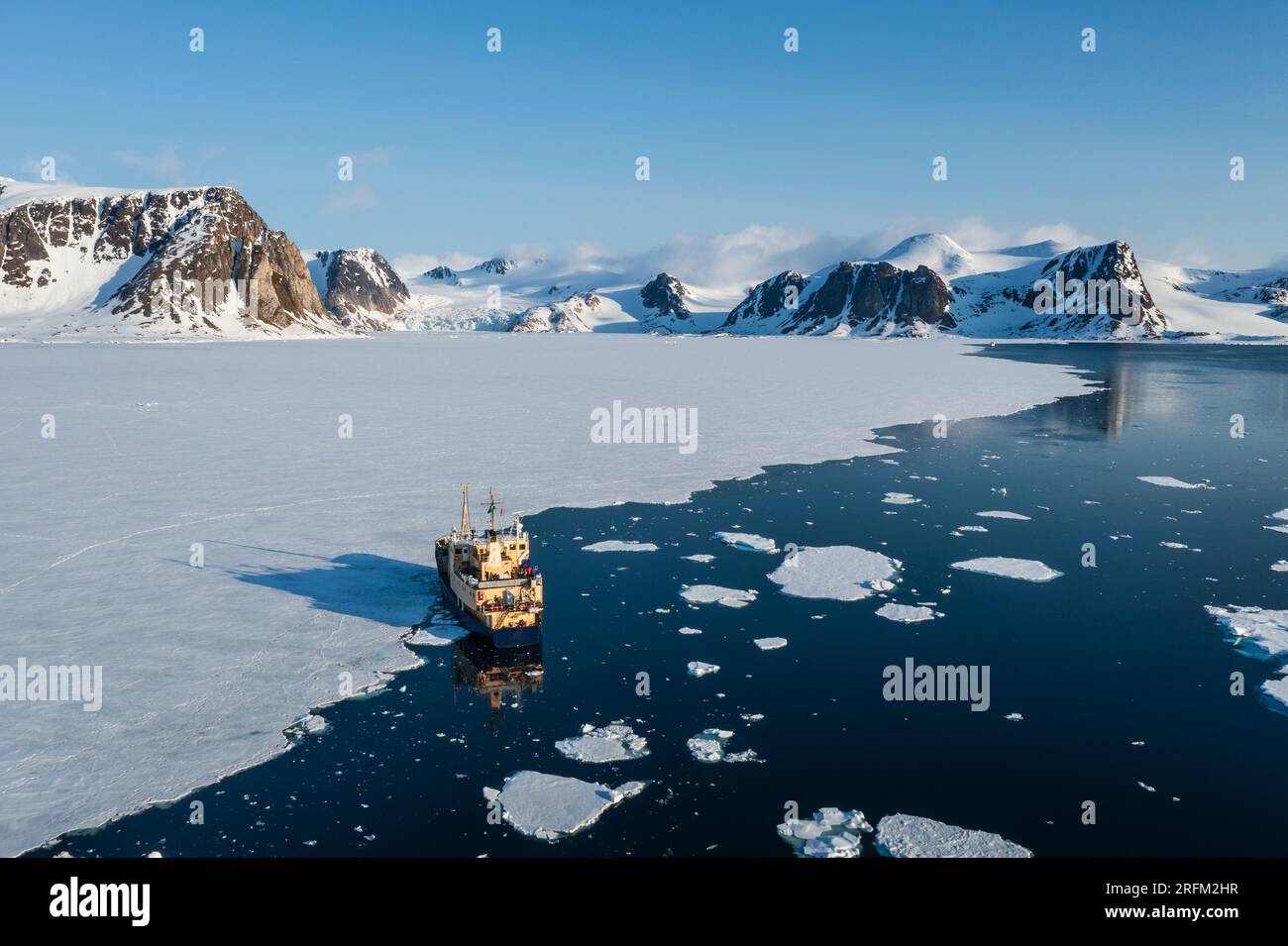 Ship cruising through the ice in Svalbard Stock Photo - Alamy