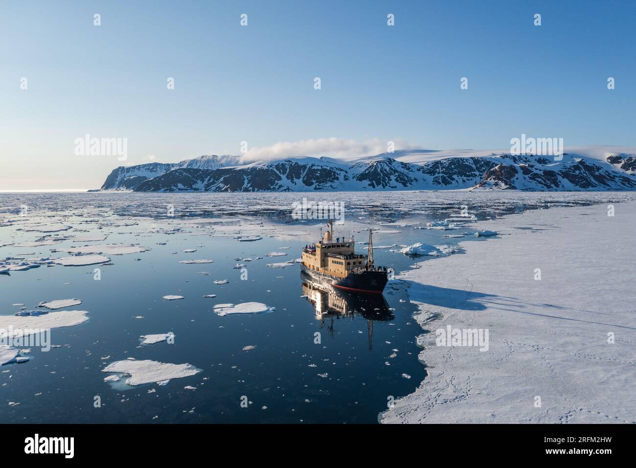 Ship cruising through the ice in Svalbard Stock Photo - Alamy