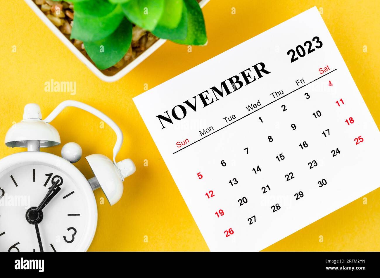 November 2023 Monthly calendar for 2023 year with alarm clock on yellow ...