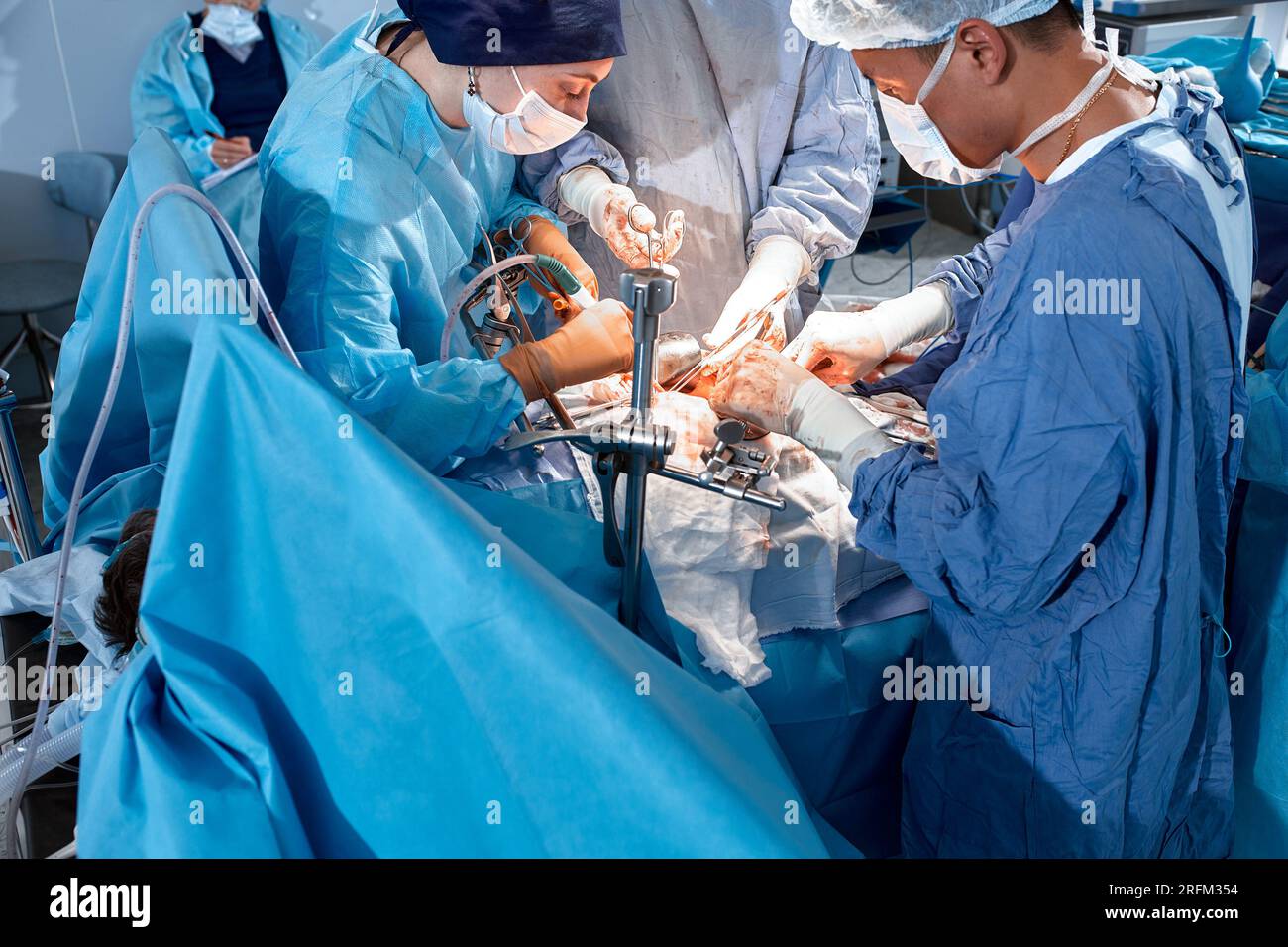 Surgeons team during complex surgical operation in a sterile operating ...