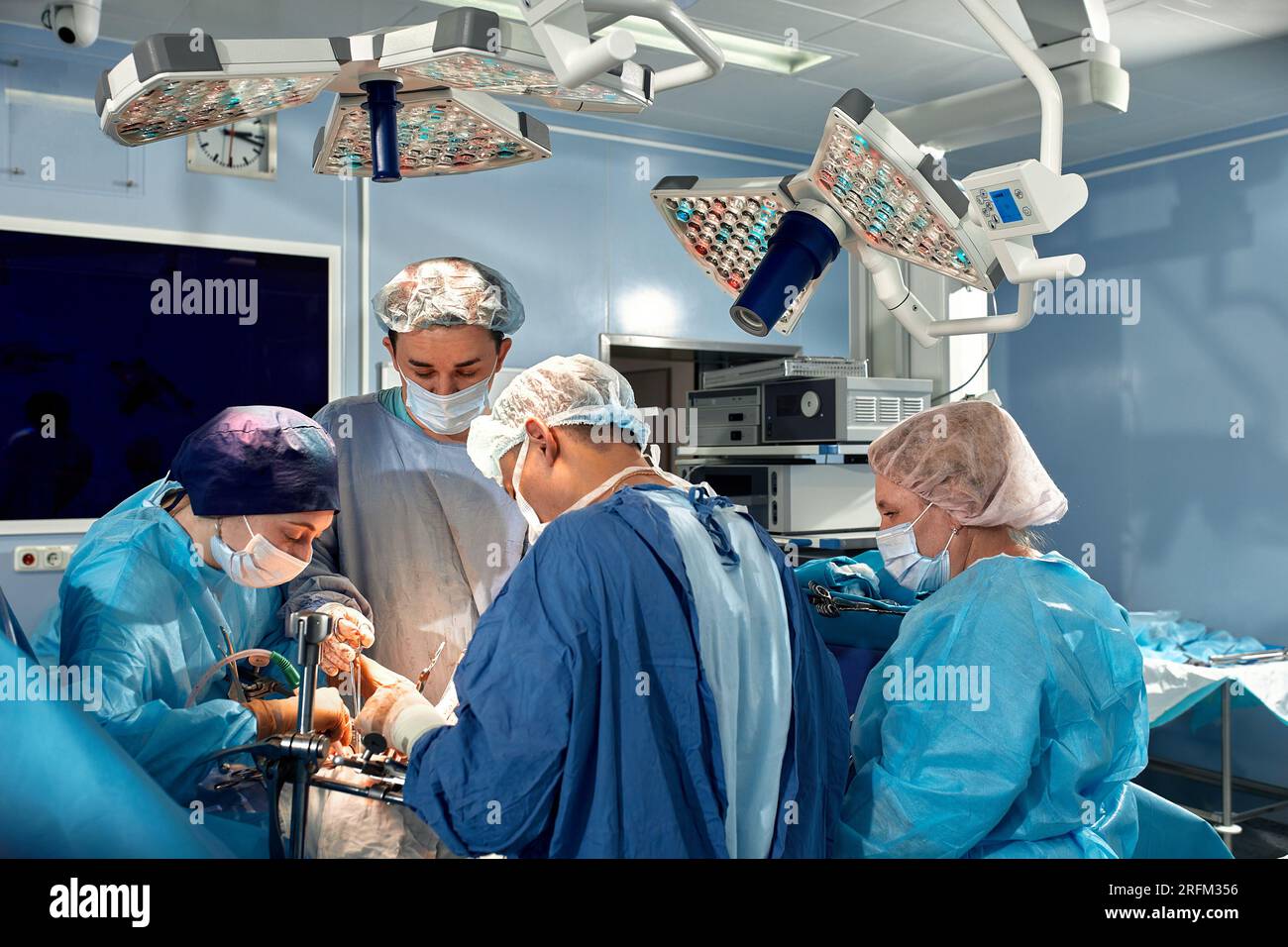 Surgeons team during complex surgical operation in a sterile operating ...