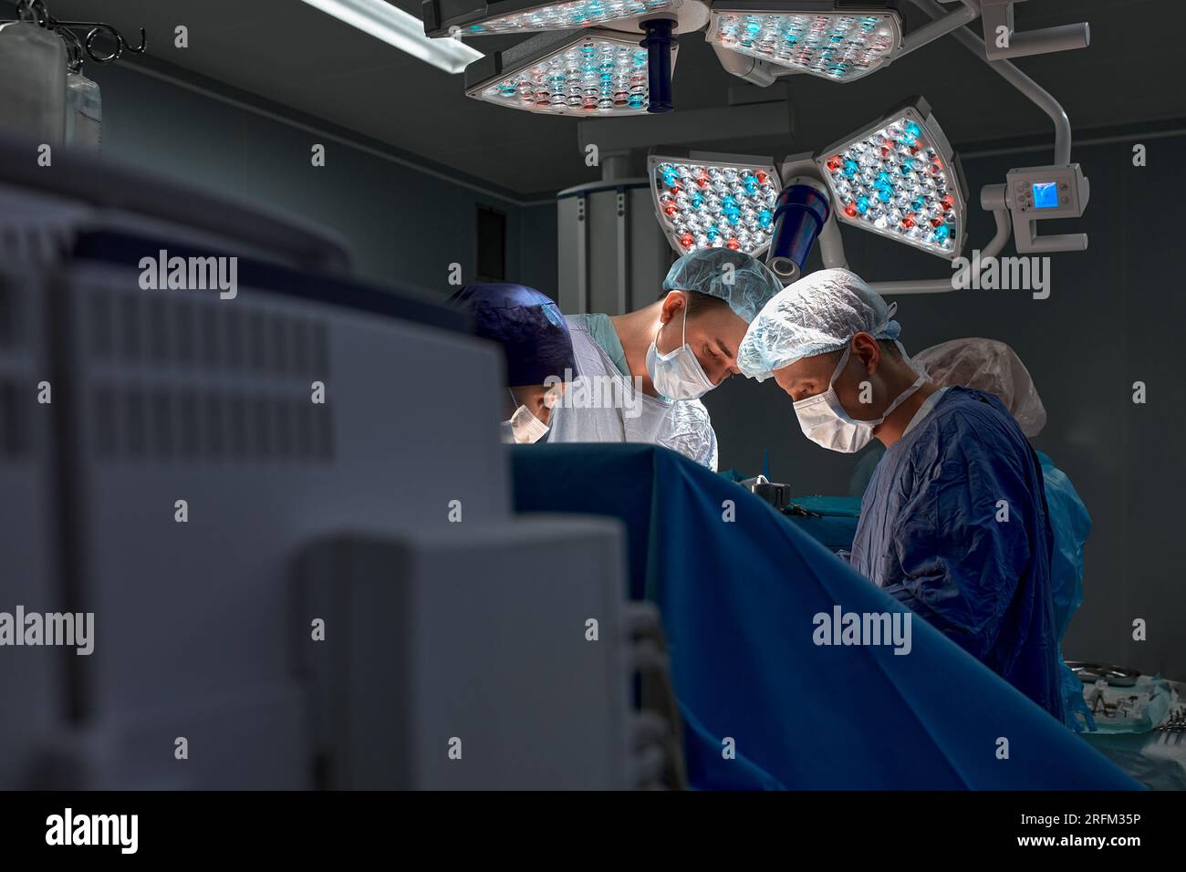 Surgeons team during complex surgical operation in a sterile operating ...
