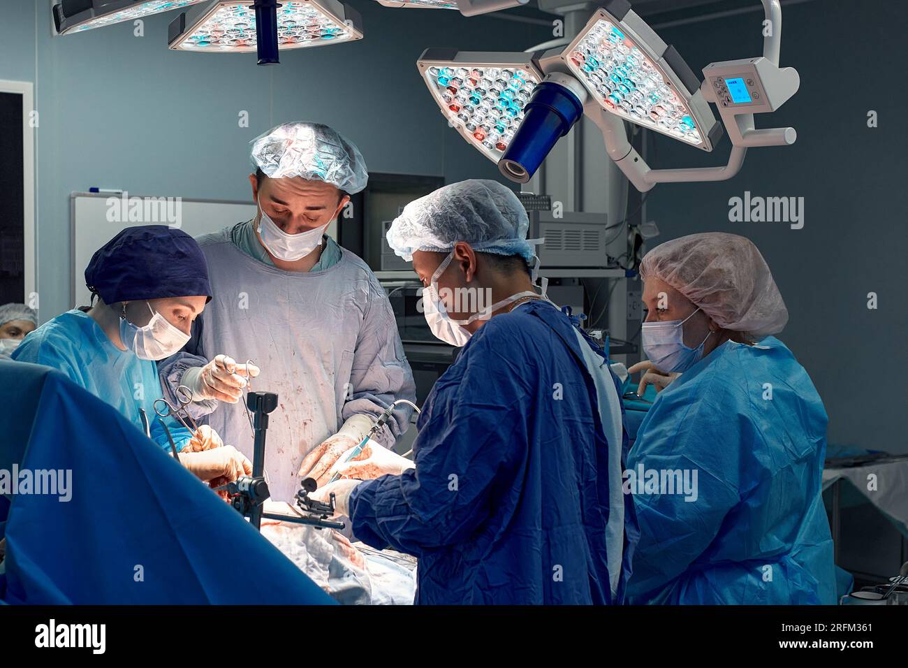 Surgeons team during complex surgical operation in a sterile operating ...