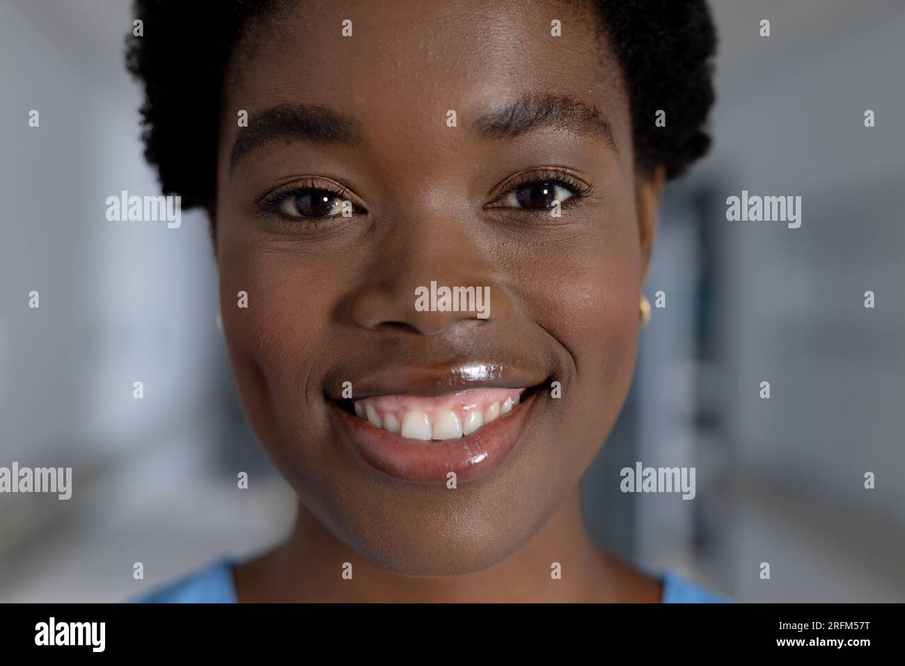Portrait of happy african american female doctor wearing scrubs in ...