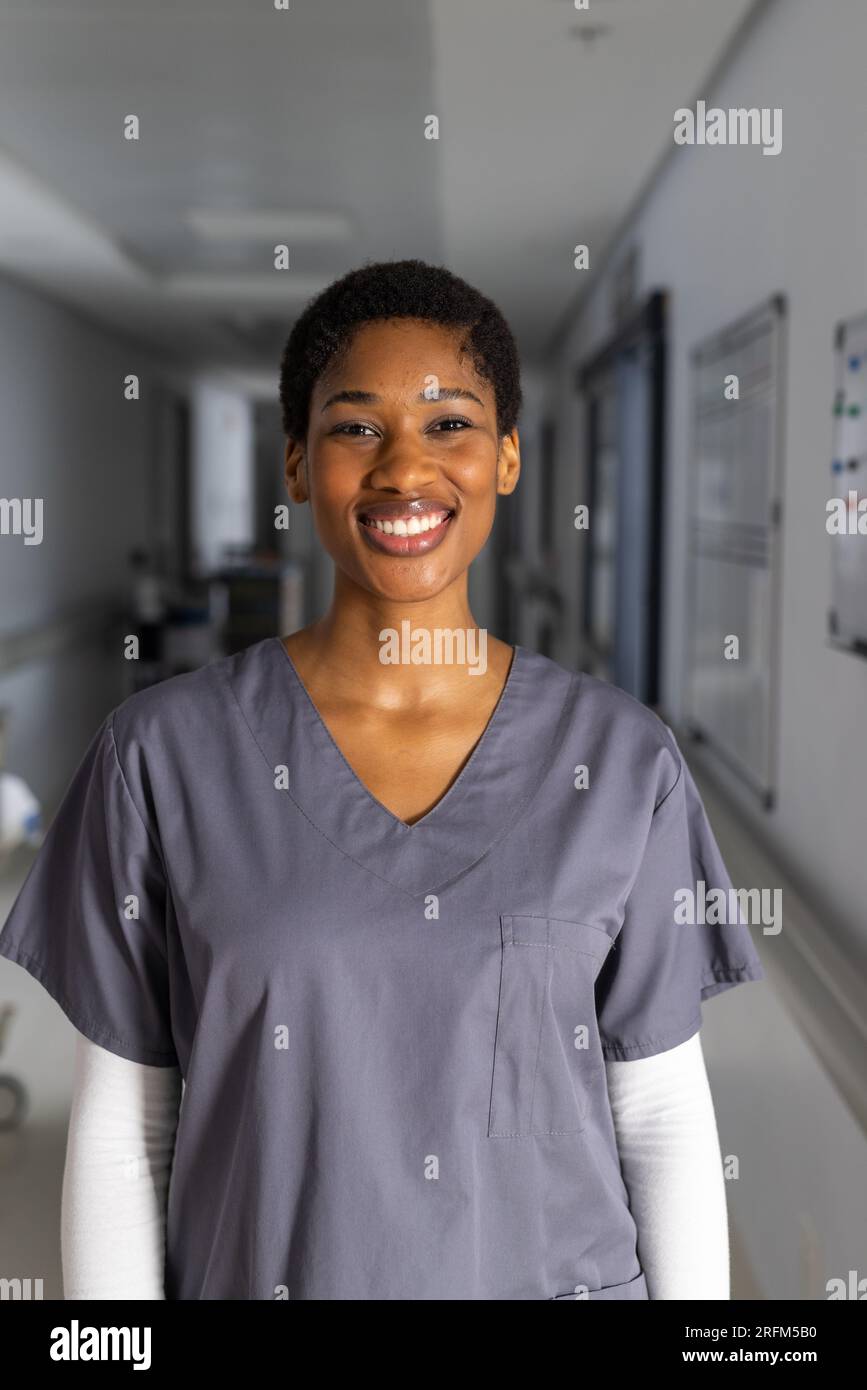 Portrait of happy african american female doctor wearing scrubs in ...