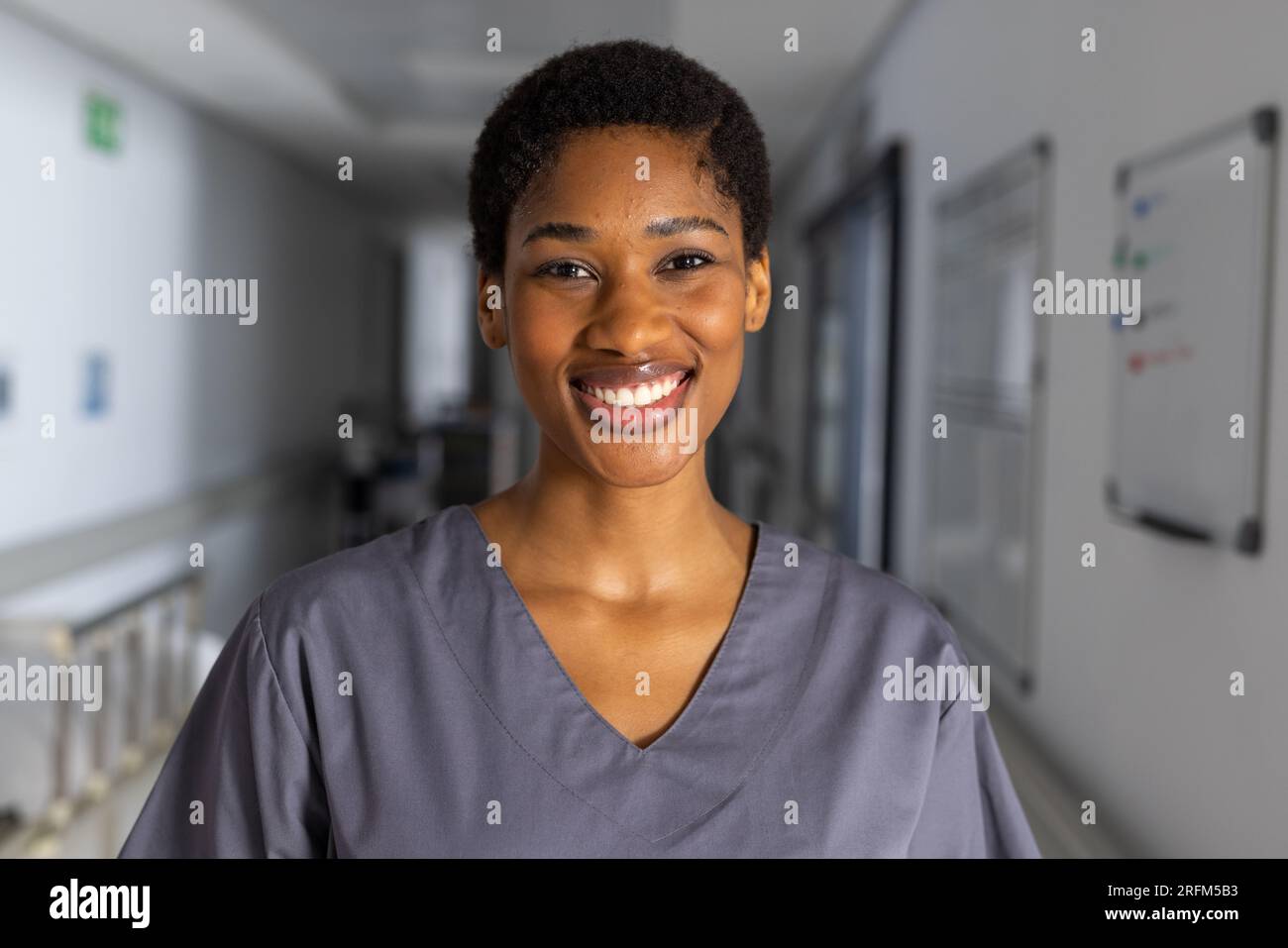 Portrait of happy african american female doctor wearing scrubs in ...
