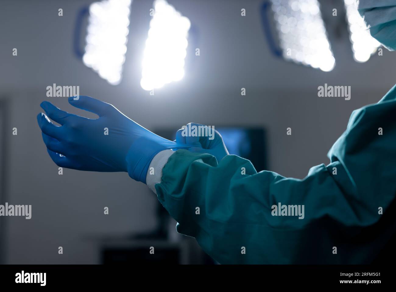 African american female surgeon wearing surgical gown and gloves in ...