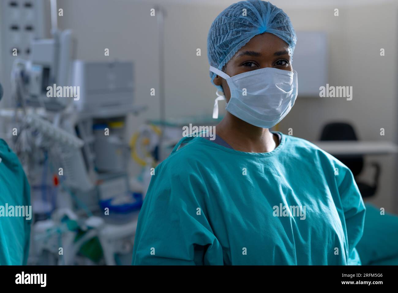 Portrait of african american female surgeon wearing surgical gown in ...