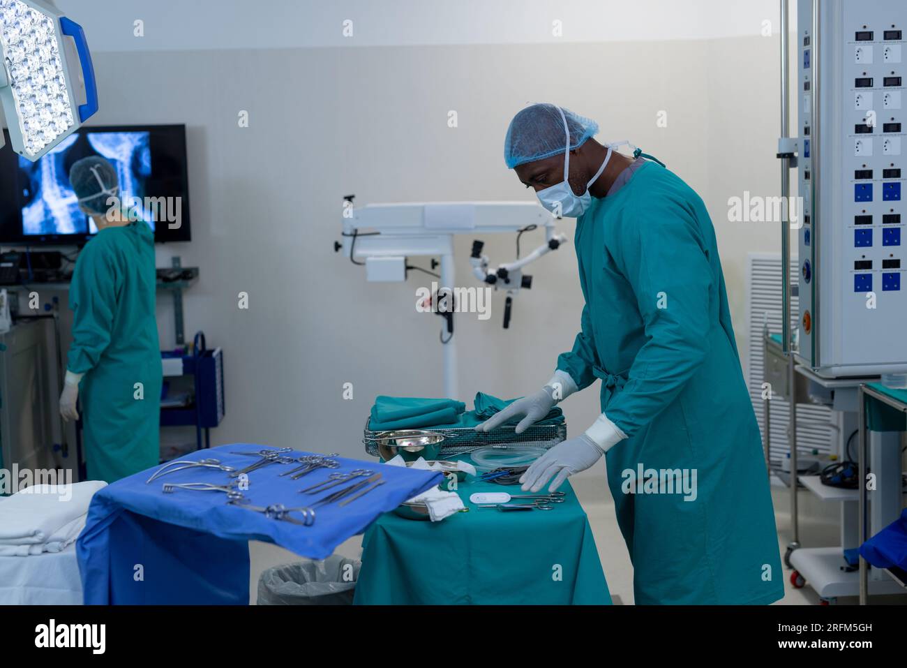 African american male surgeon preparing surgical instruments in ...