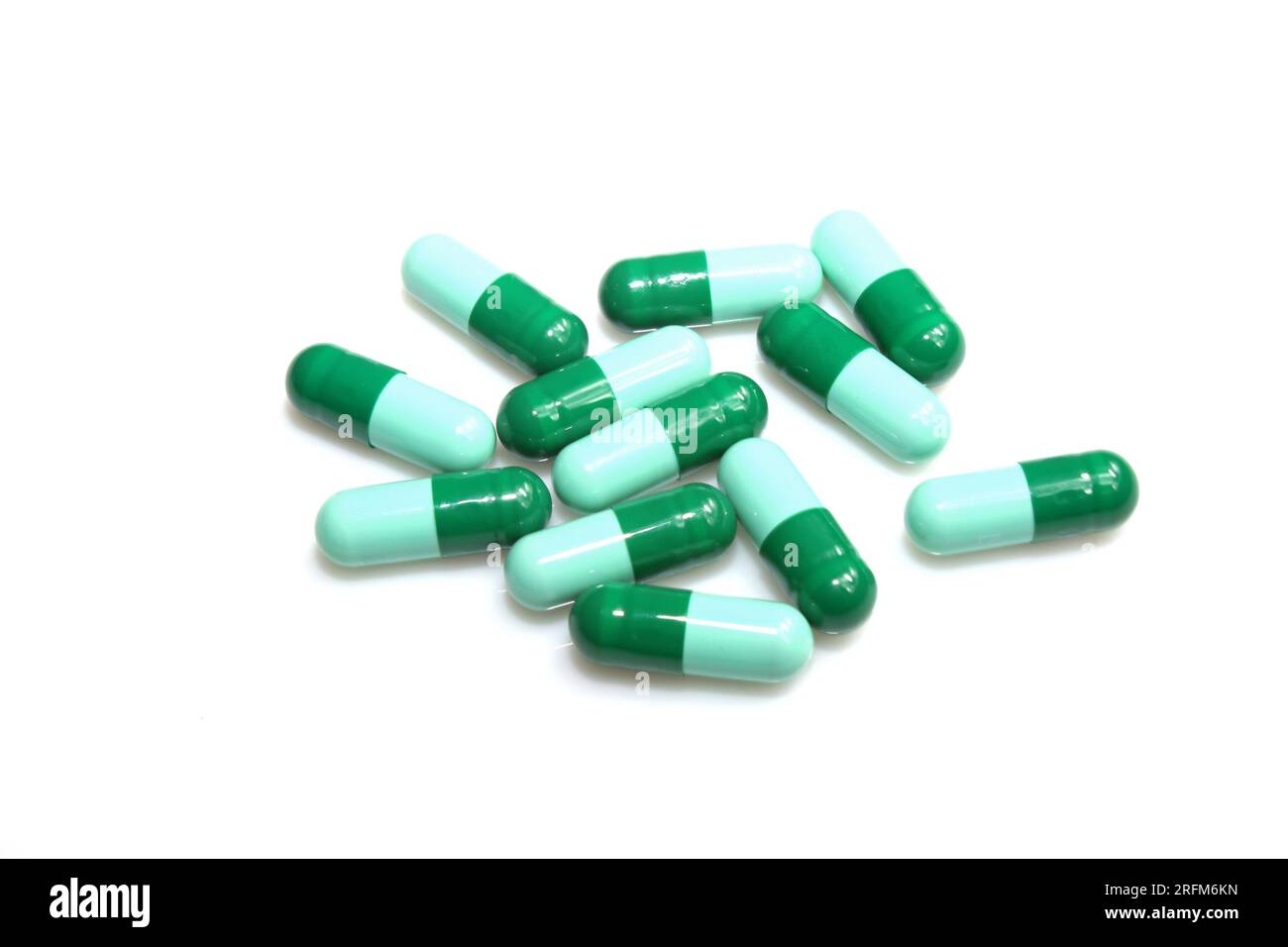 green tablet drug on a white background Stock Photo - Alamy