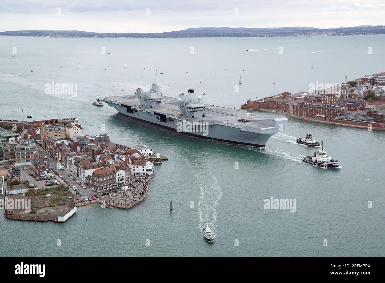 Aircraft carrier HMS Prince of Wales is towed to Portsmouth Naval Base ...