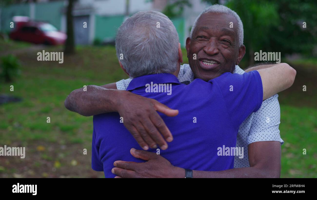Two diverse Brazilian senior Friends Share Warm Embrace in Park. Old ...