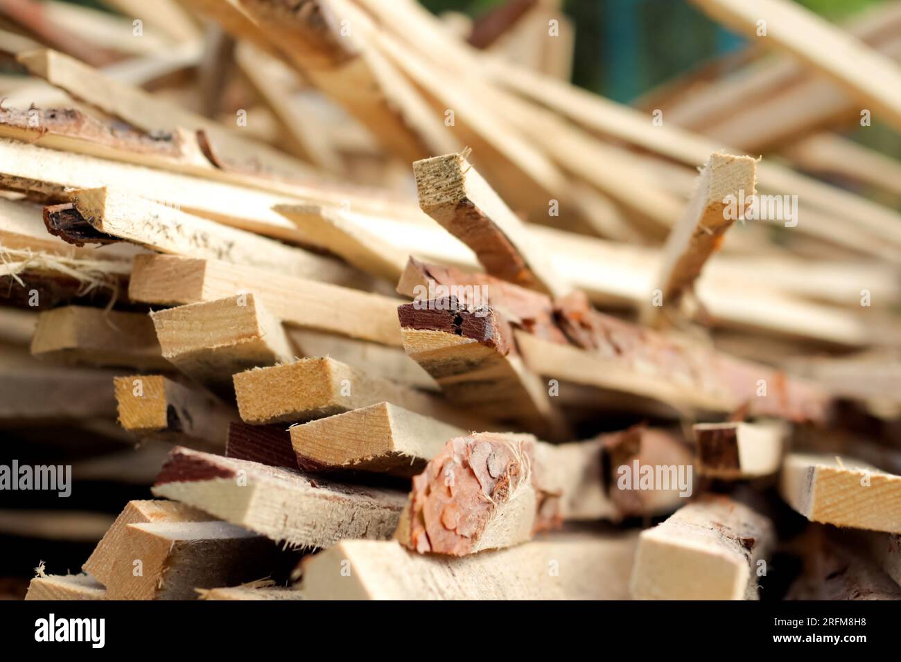 At the sawmill, piles of wooden boards await planking. This outdoor ...