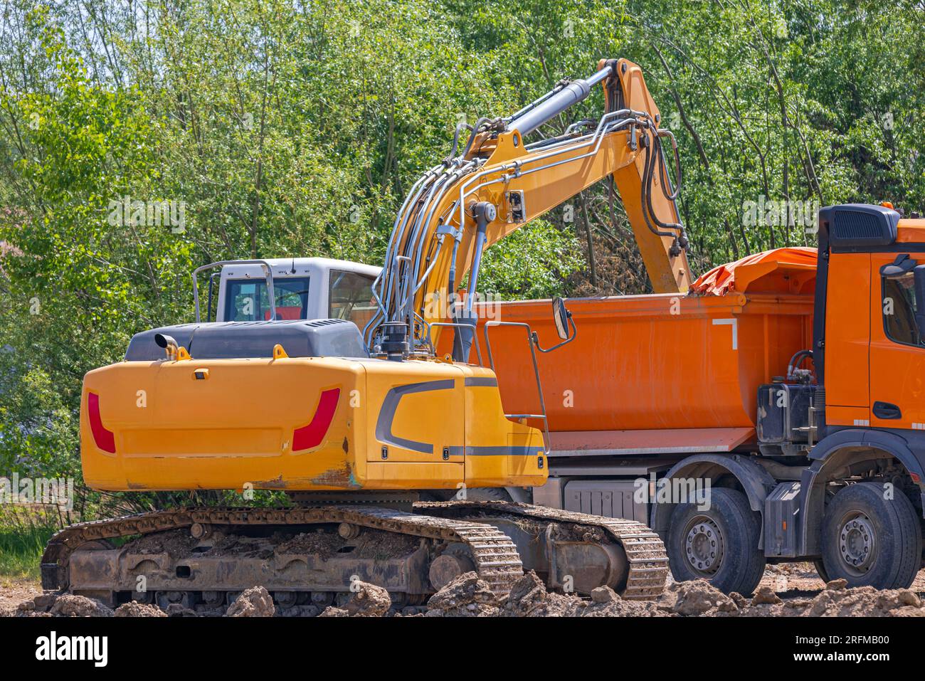 Excavator Loading Dirt in Tipper Truck at Construction Site Stock Photo ...